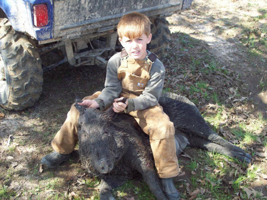 Gavin Burris with a picture of one of the two hogs caught in Wiggins, MS on 02/21/2009.